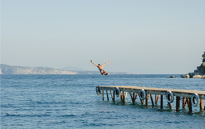 Jumping into the Ocean at Agni Beach in Corfu Greece - Entouriste